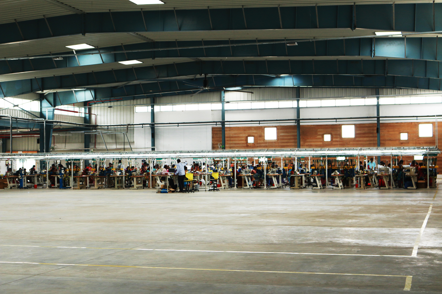 A long shot of the factory’s interior focusing on the tailoring units ...
